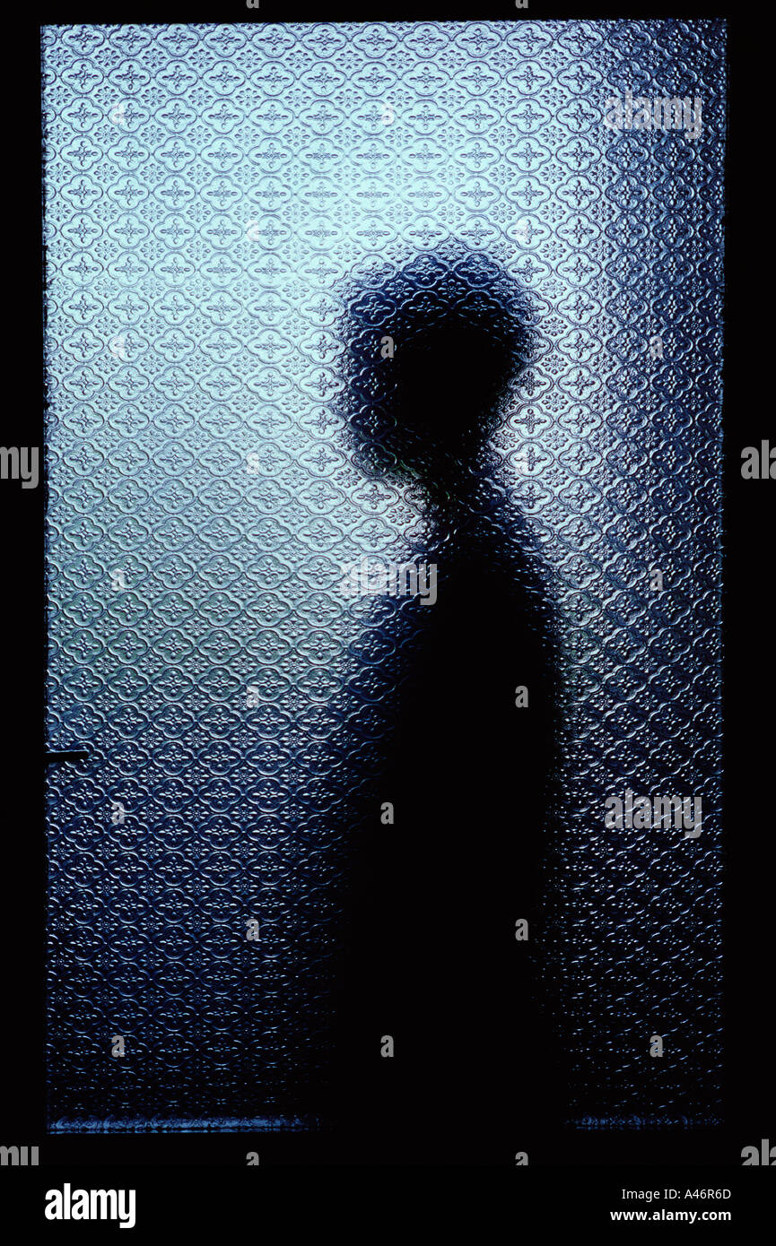 Silhouetted person through window Stock Photo - Alamy