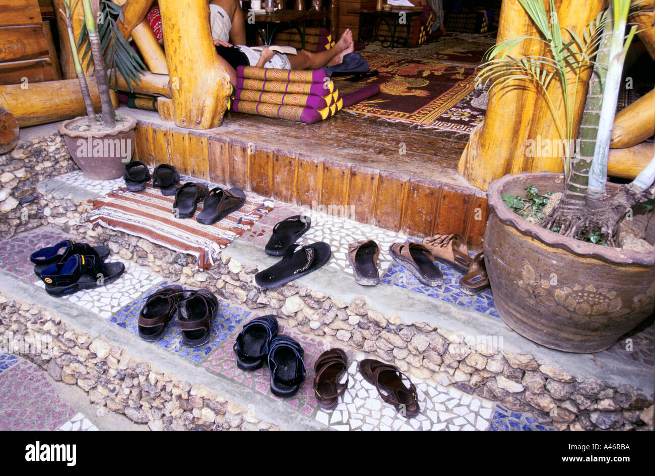 western travellers sandals outside a beach bar on the island of koh pha ...
