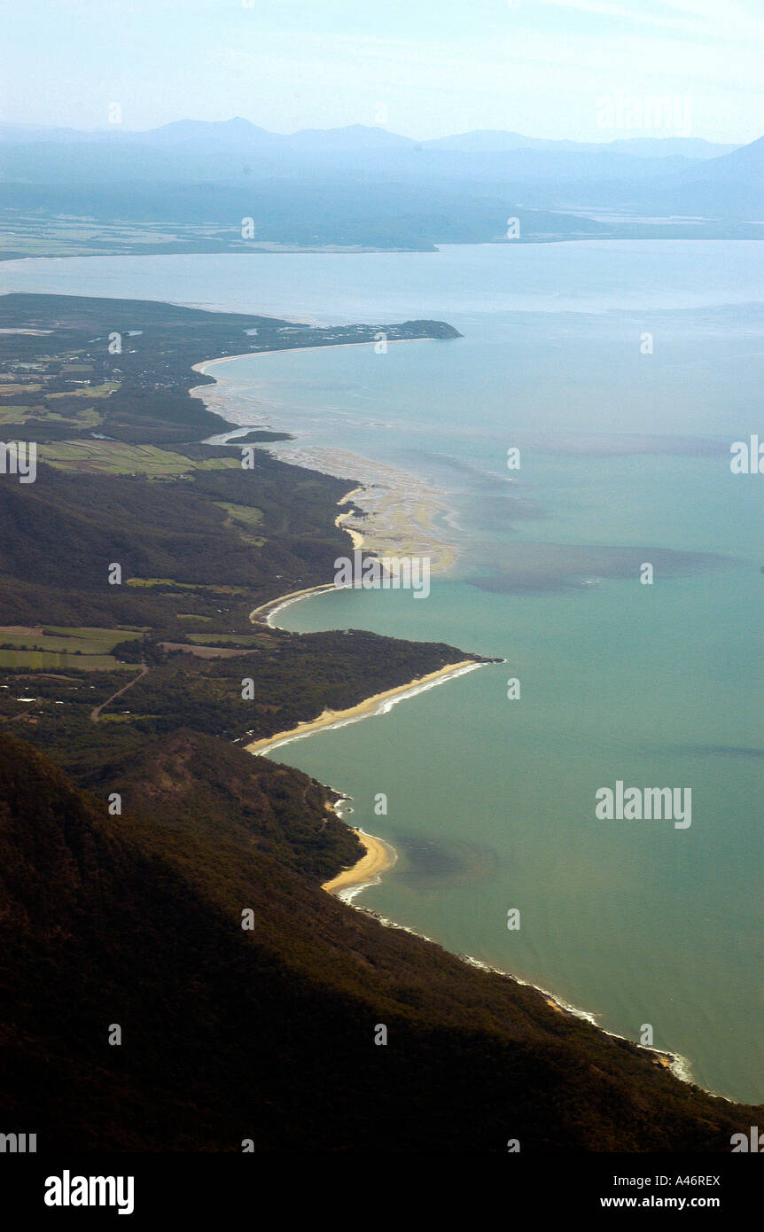 Aerial view of Queensland coastline with houses built next to the ocean ...