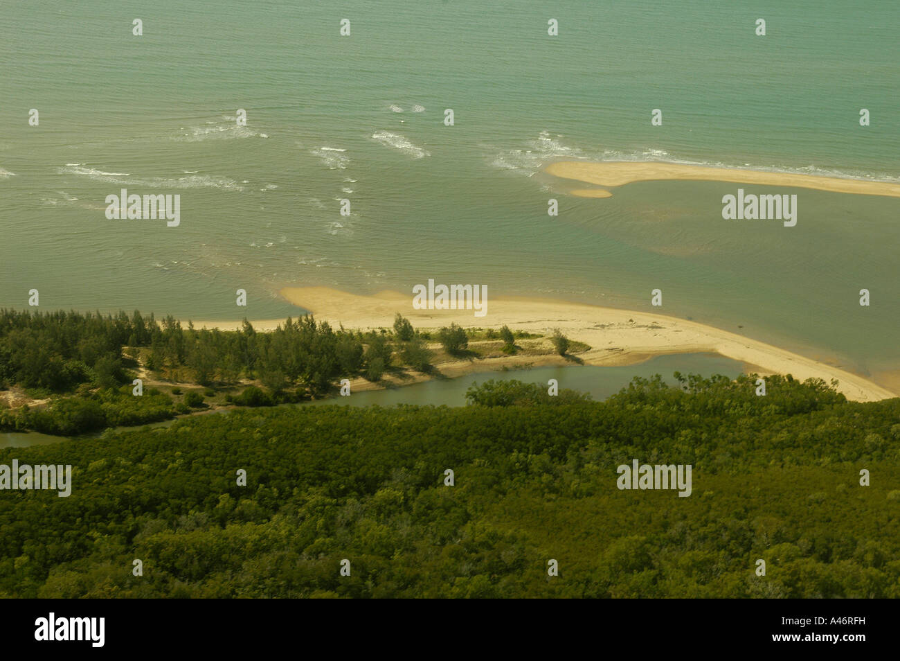Aerial view of Queensland coastline with houses built next to the ocean ...