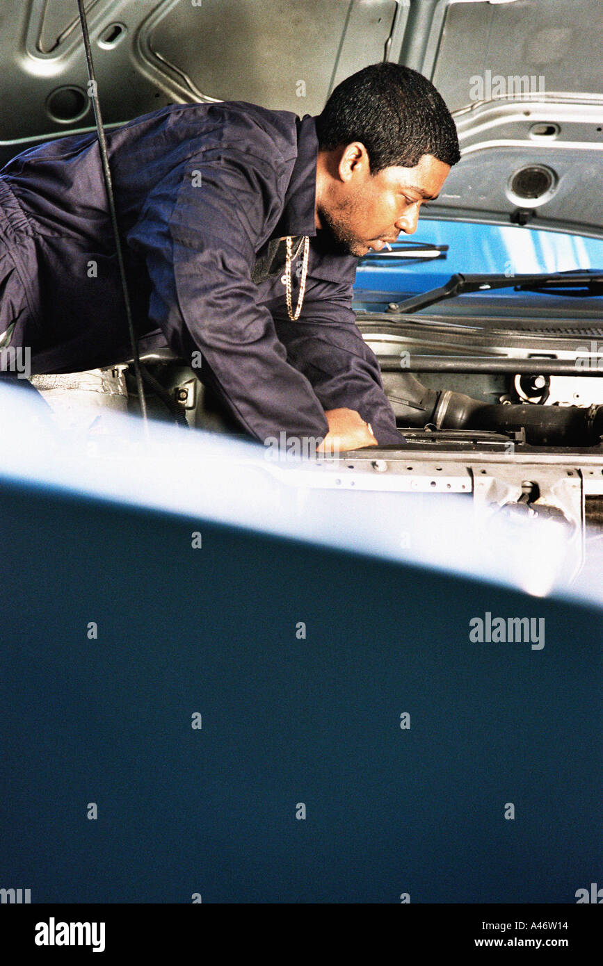 Mechanic working on engine Stock Photo - Alamy