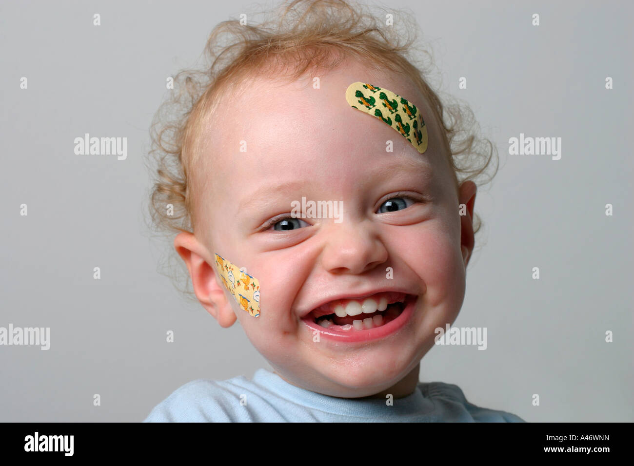 A little boy with two band-aids Stock Photo - Alamy