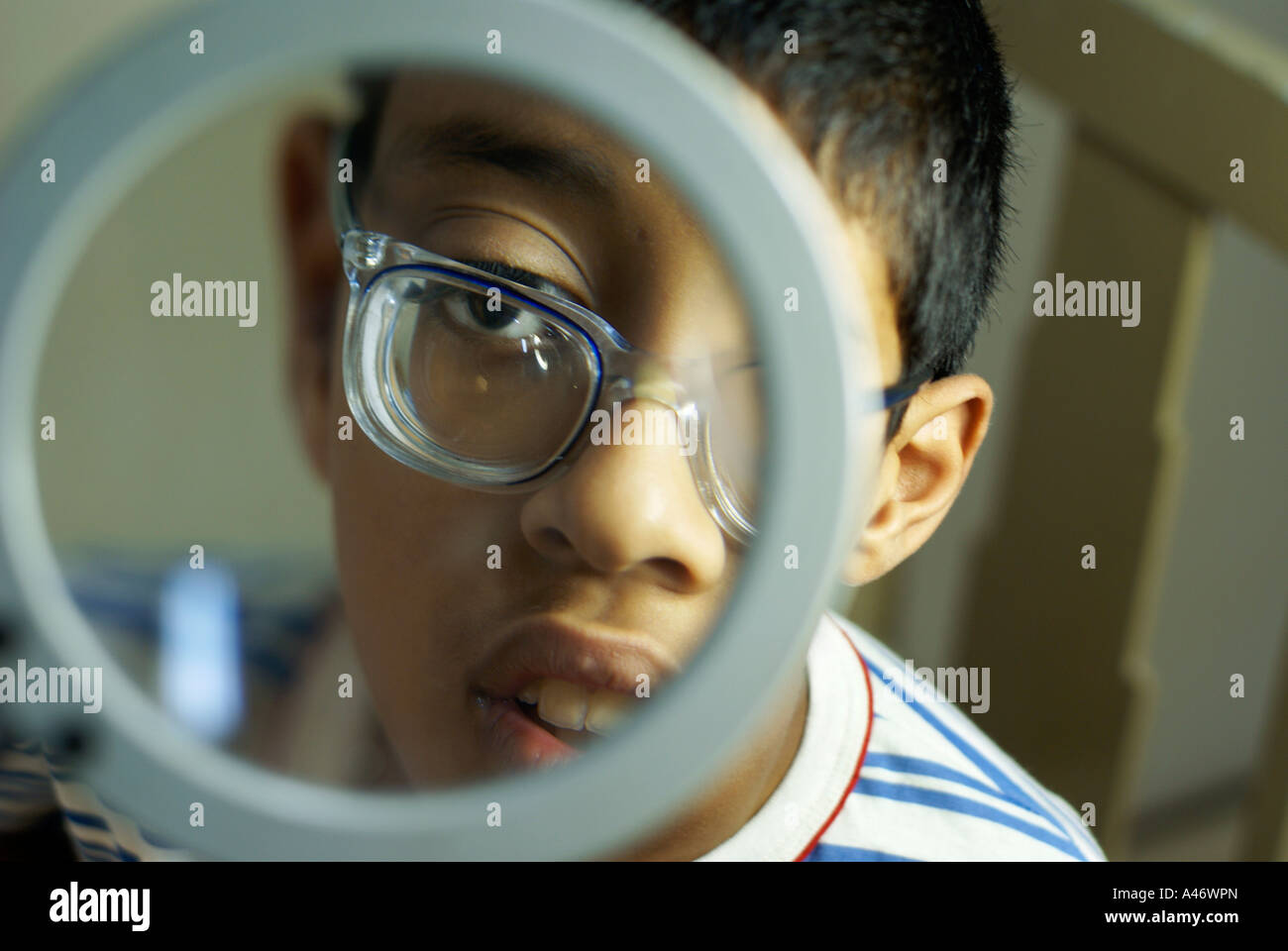 Boy strong eyeglasses behind a loop hi-res stock photography and images ...