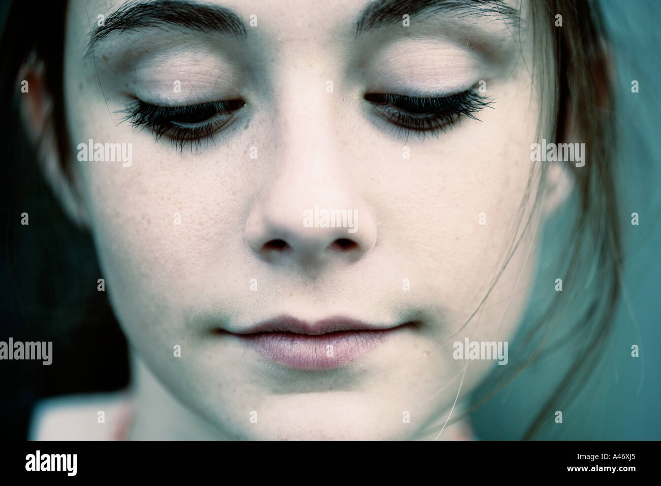 Portrait of a pretty girl looking down Stock Photo - Alamy