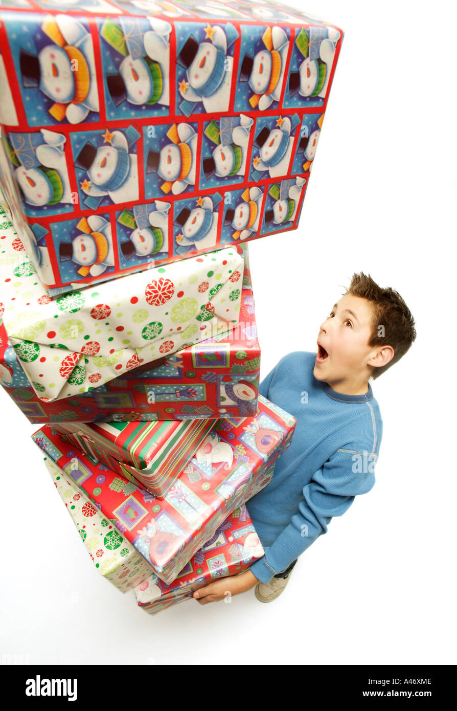 Child with a stack of presents Stock Photo - Alamy