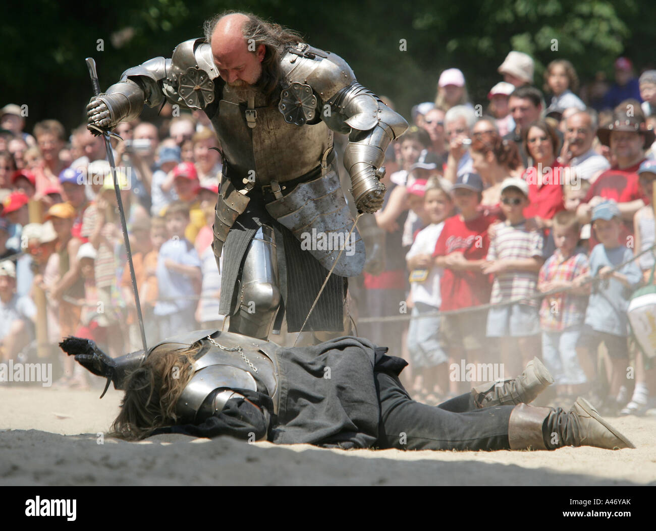 Two knights are fighting with swords at a show on the fortress ...