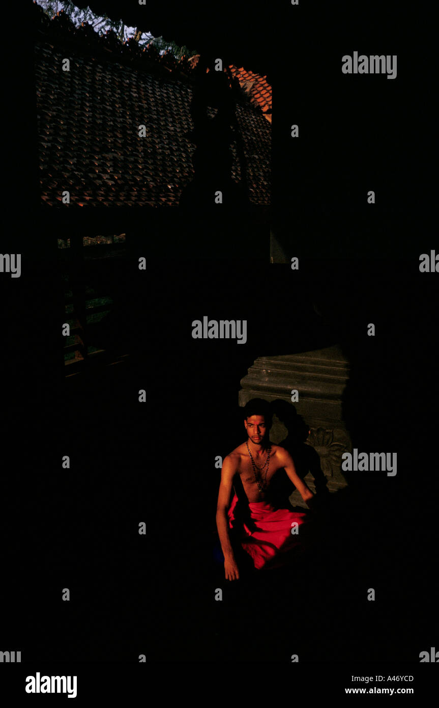 A Kathakali student sits in the Koothambalam, the sacred temple theatre ...