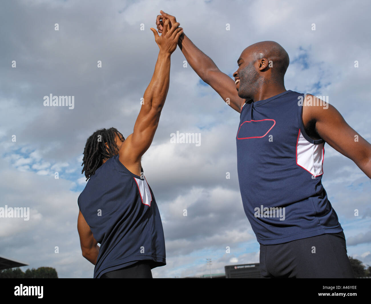Male athletes high five hi-res stock photography and images - Alamy