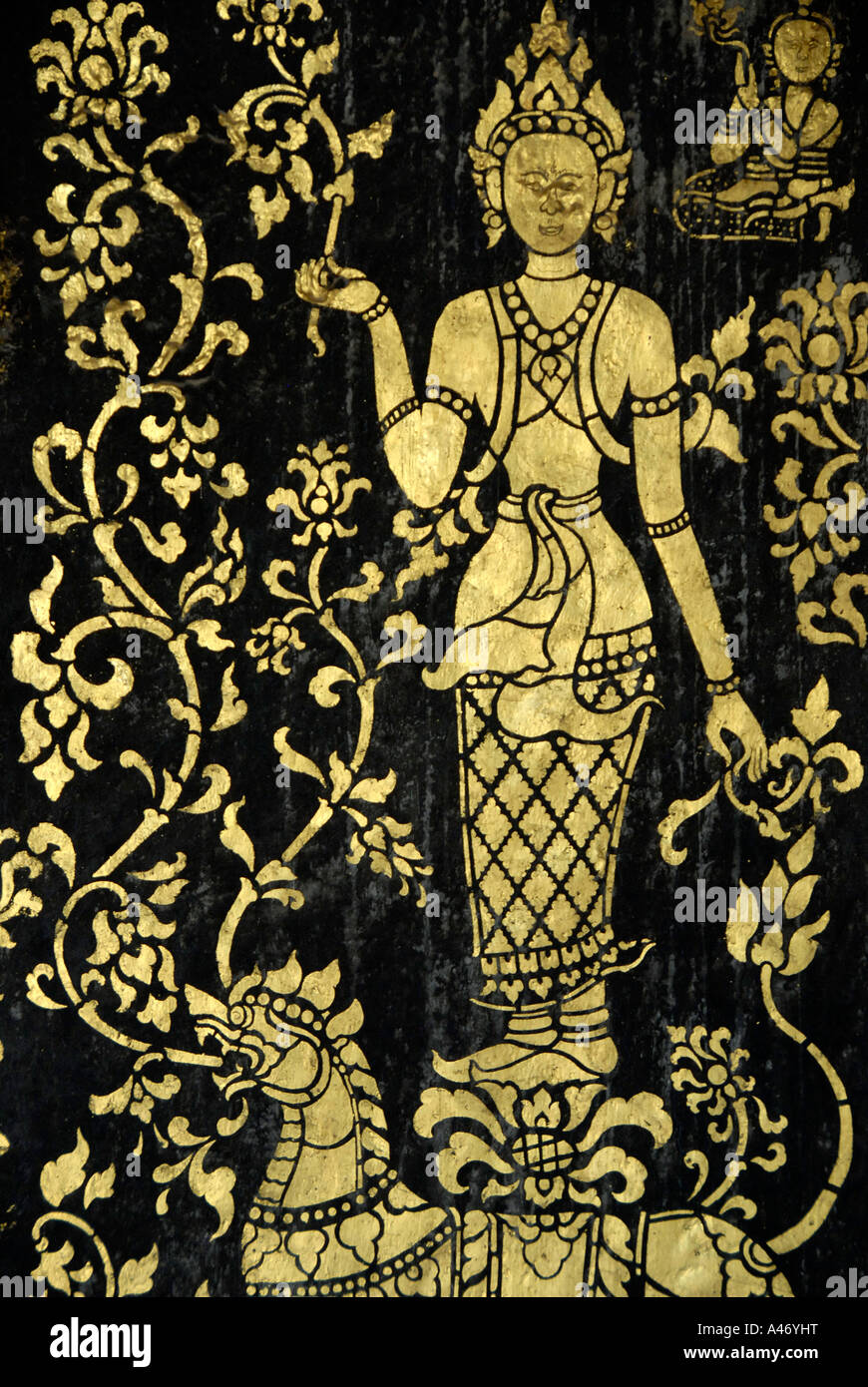 Mythic being art detail of the decorated walls at temple Wat Xieng ...
