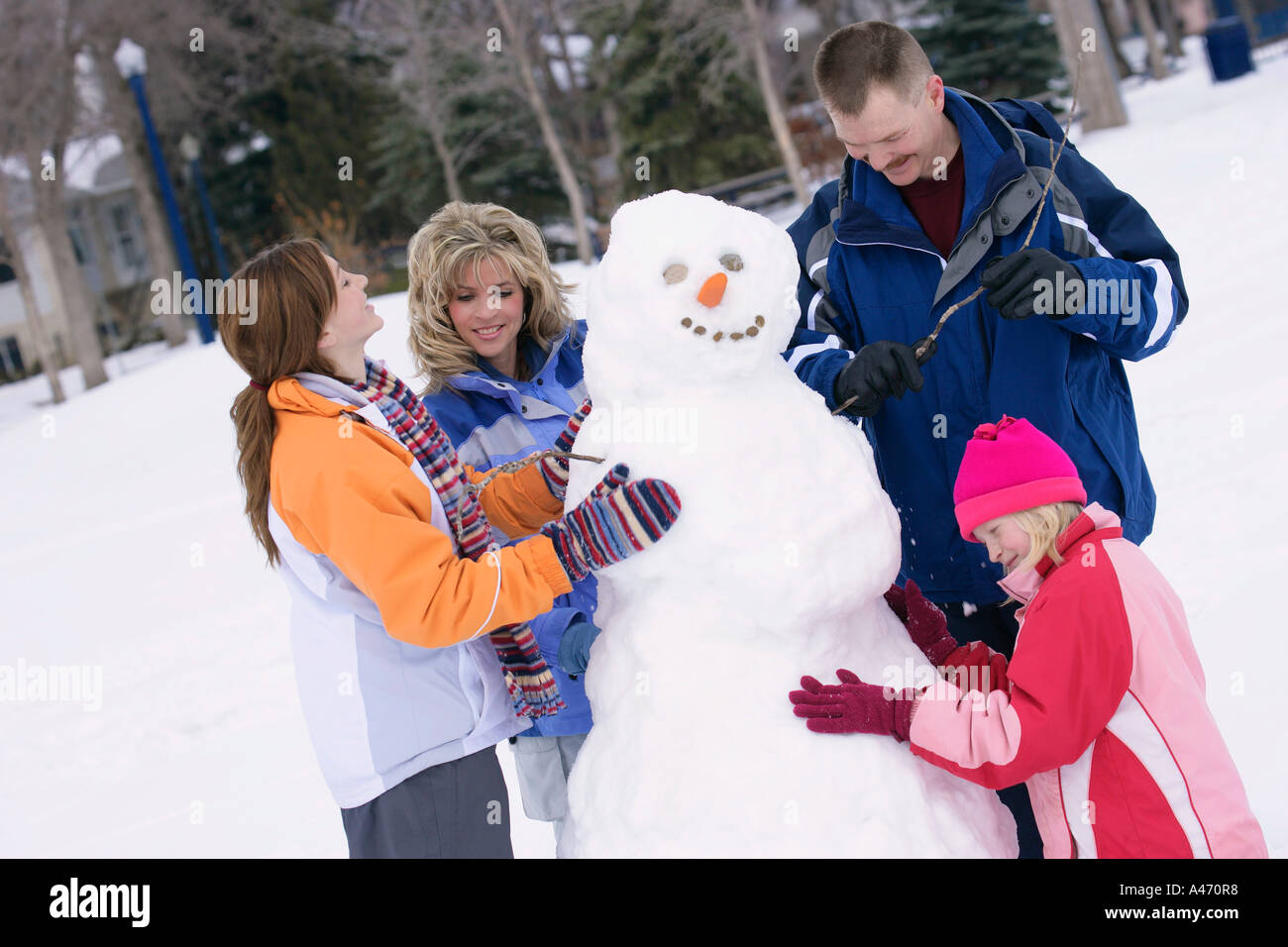 Family builds a snowman hi-res stock photography and images - Alamy