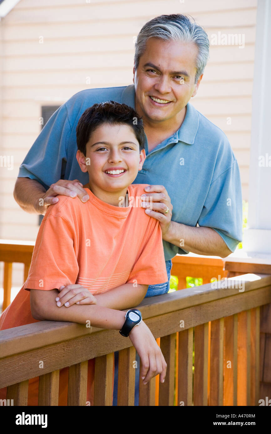 Hispanic father and son smiling on porch Stock Photo - Alamy