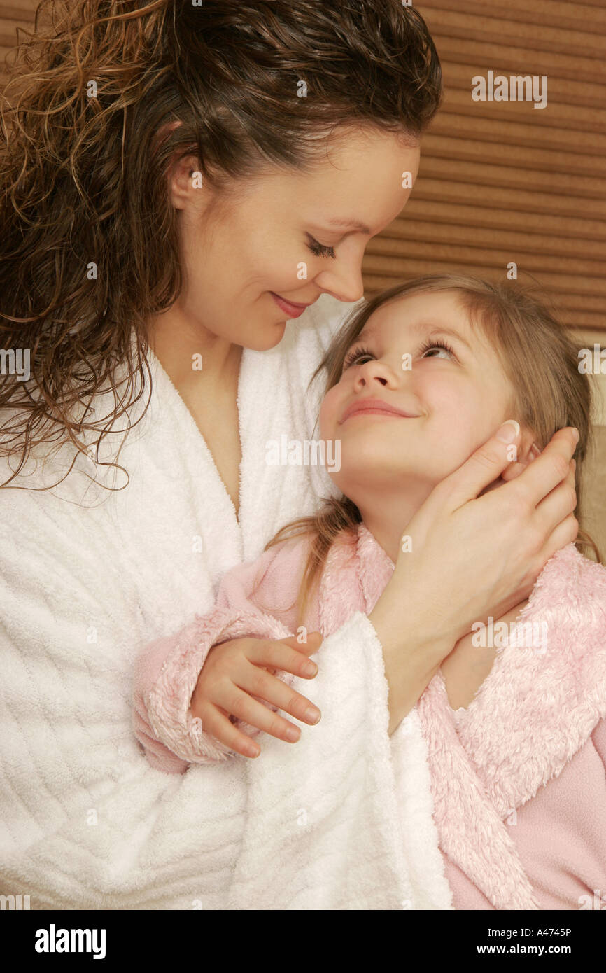 Mom and daughter in robes Stock Photo - Alamy