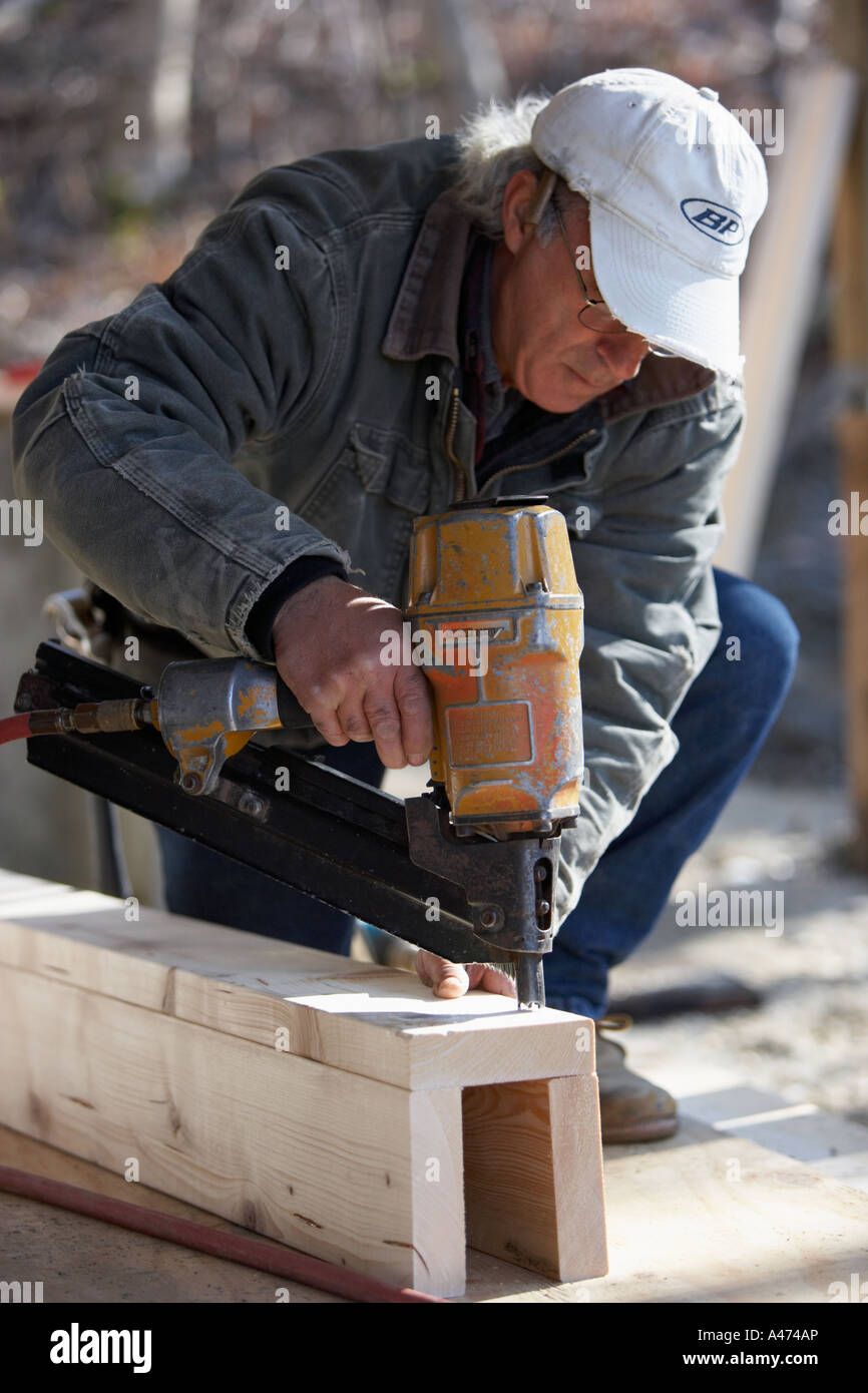 Construction worker building a deck on a residence Stock Photo - Alamy