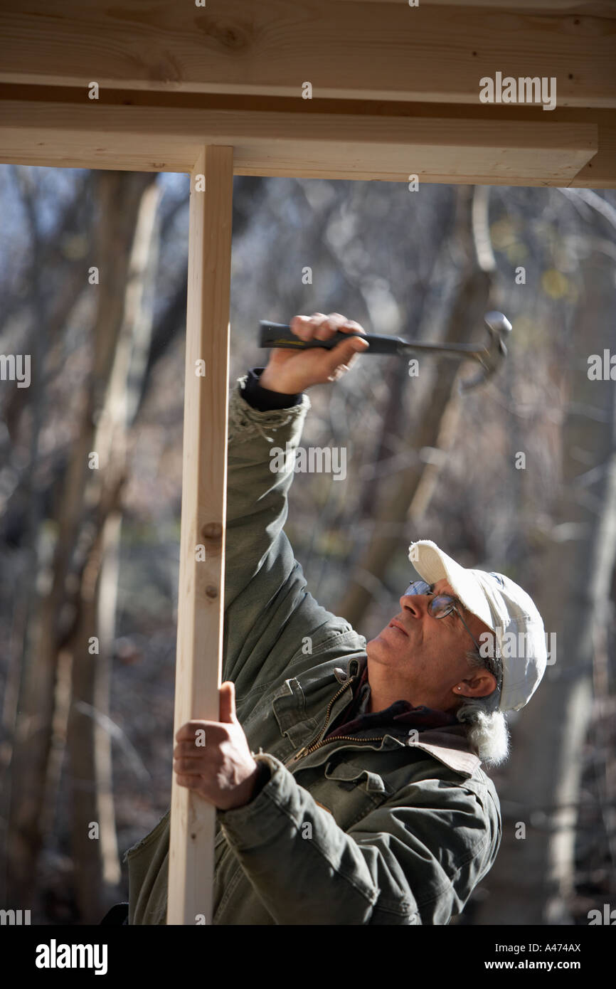 Construction worker building a deck on a residence Stock Photo - Alamy