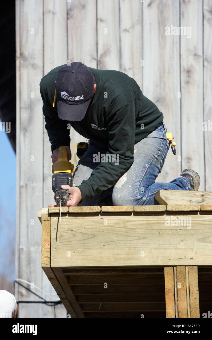 Construction worker building a deck on a residence Stock Photo - Alamy