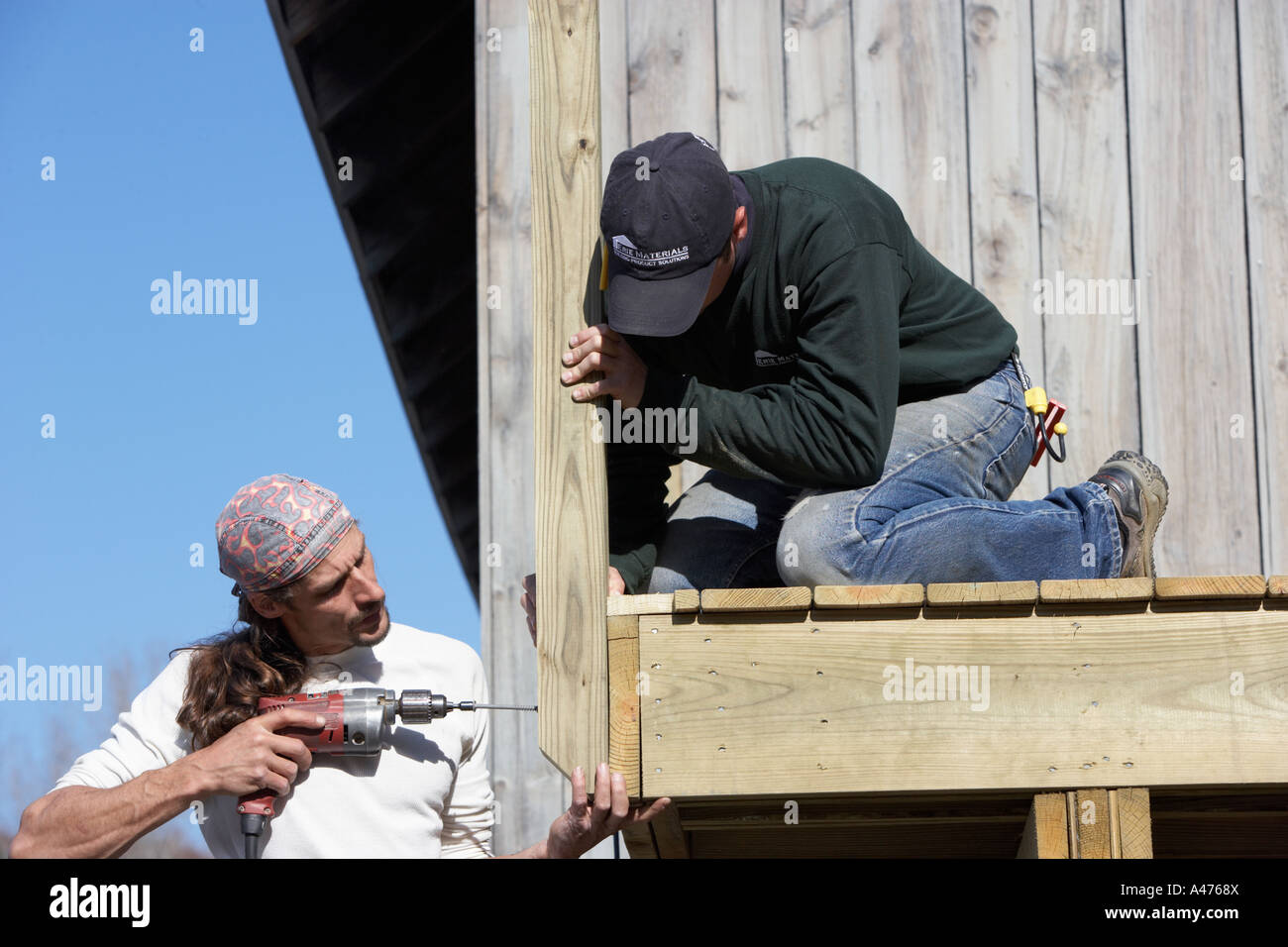 Construction workers building a deck on a residence Stock Photo - Alamy