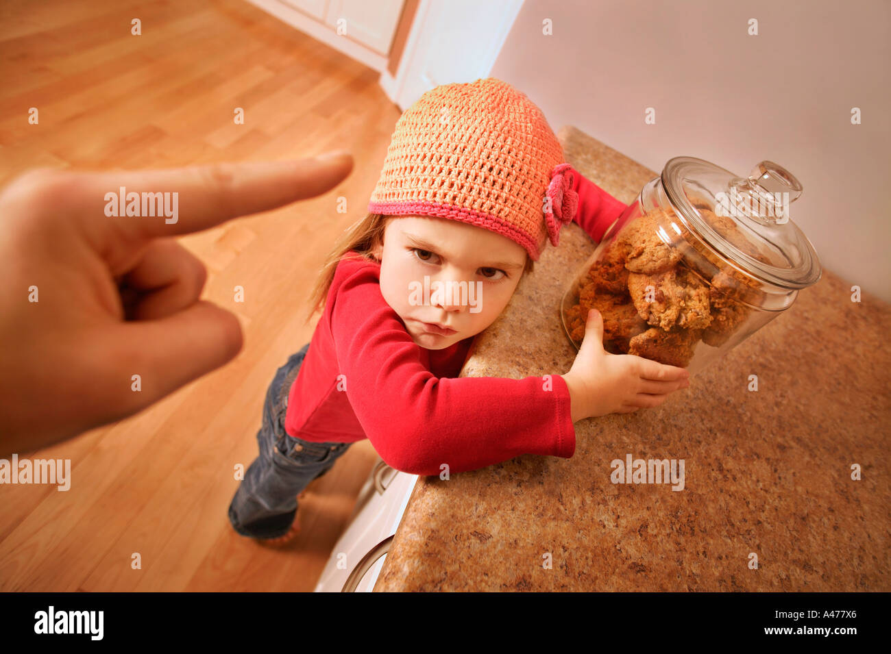 Child gets in trouble for sneaking cookies Stock Photo - Alamy