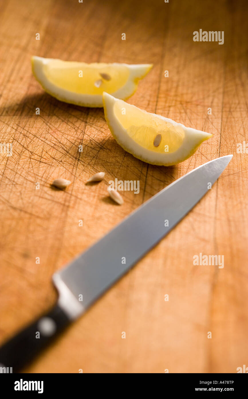 Lemon Wedge with Knife Stock Photo - Alamy