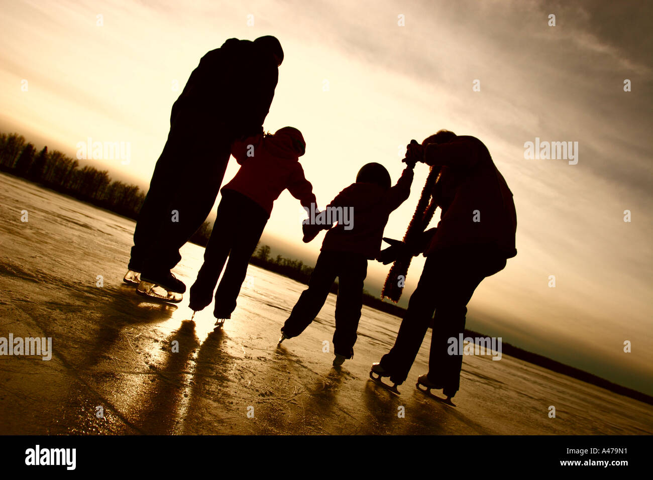 Family skating together Stock Photo - Alamy