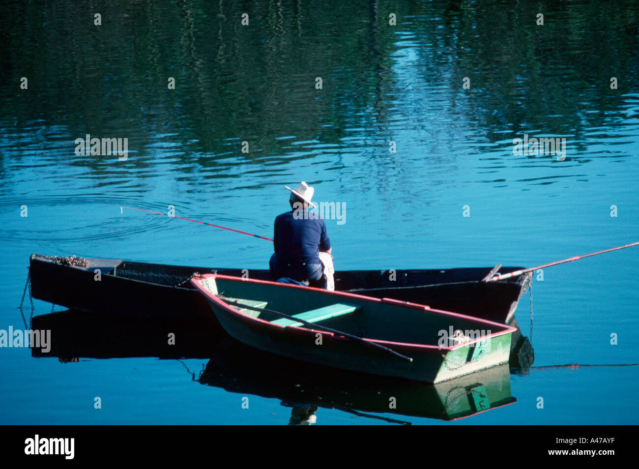 Angler in boat Stock Photo - Alamy