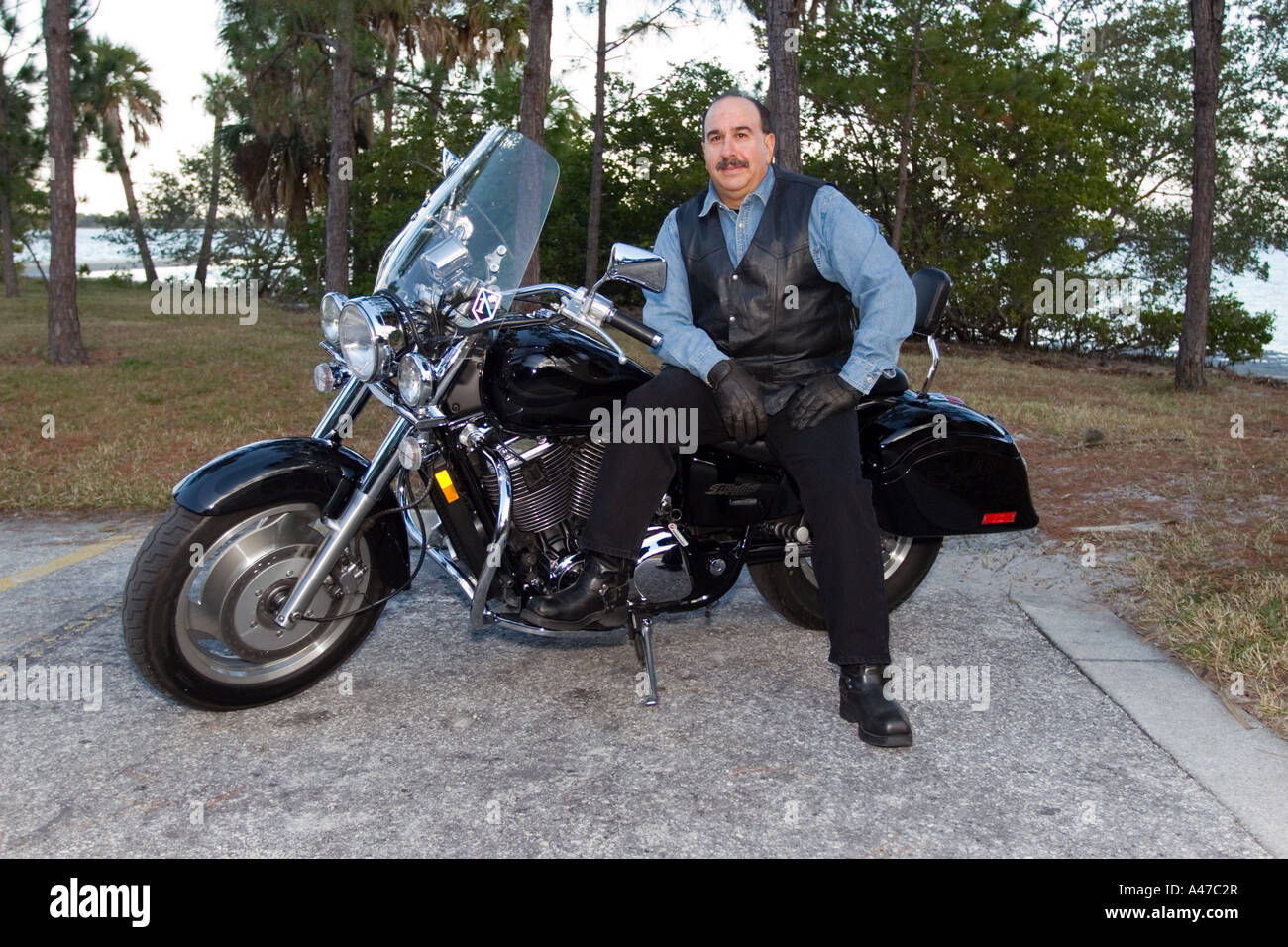 Adult Man Sitting Sideways on his Motorcycle Stock Photo - Alamy