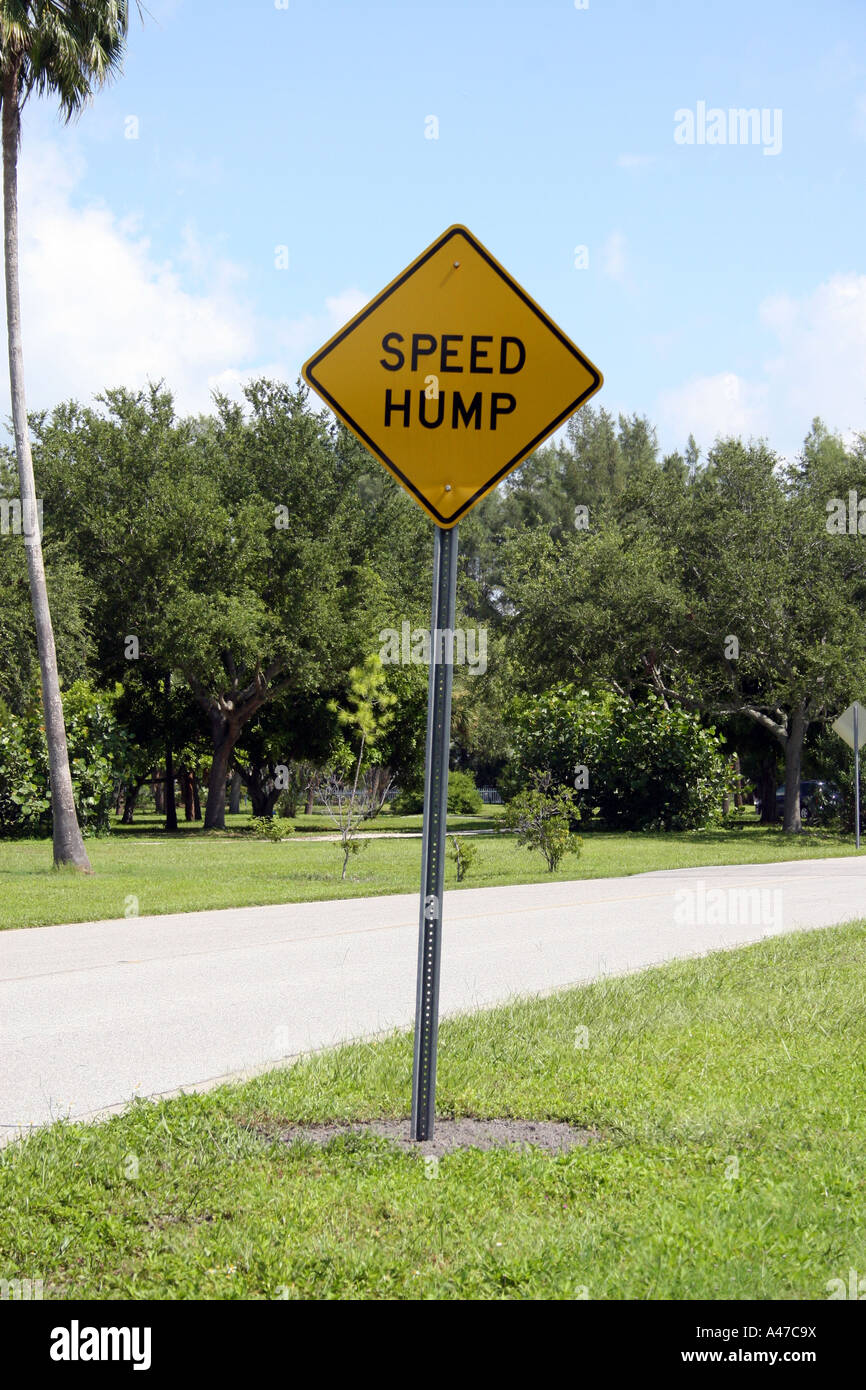 Yellow Metal Sign Indicating a Road Hump Stock Photo - Alamy