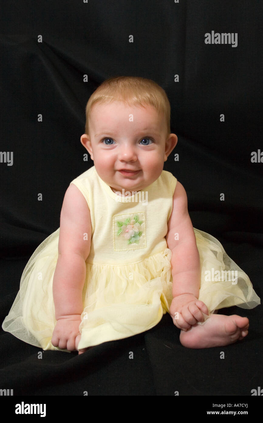 Smiling Little Girl Sitting Pretty Stock Photo - Alamy