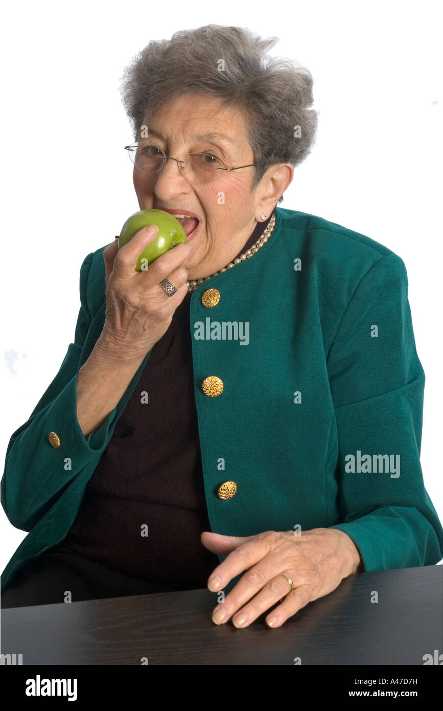 attractive senior citizen eating an apple Stock Photo - Alamy