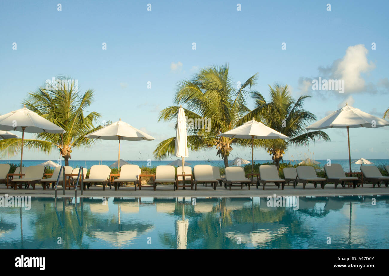 swimming pool at luxury resort with lounge chairs and umbrellas blue ...
