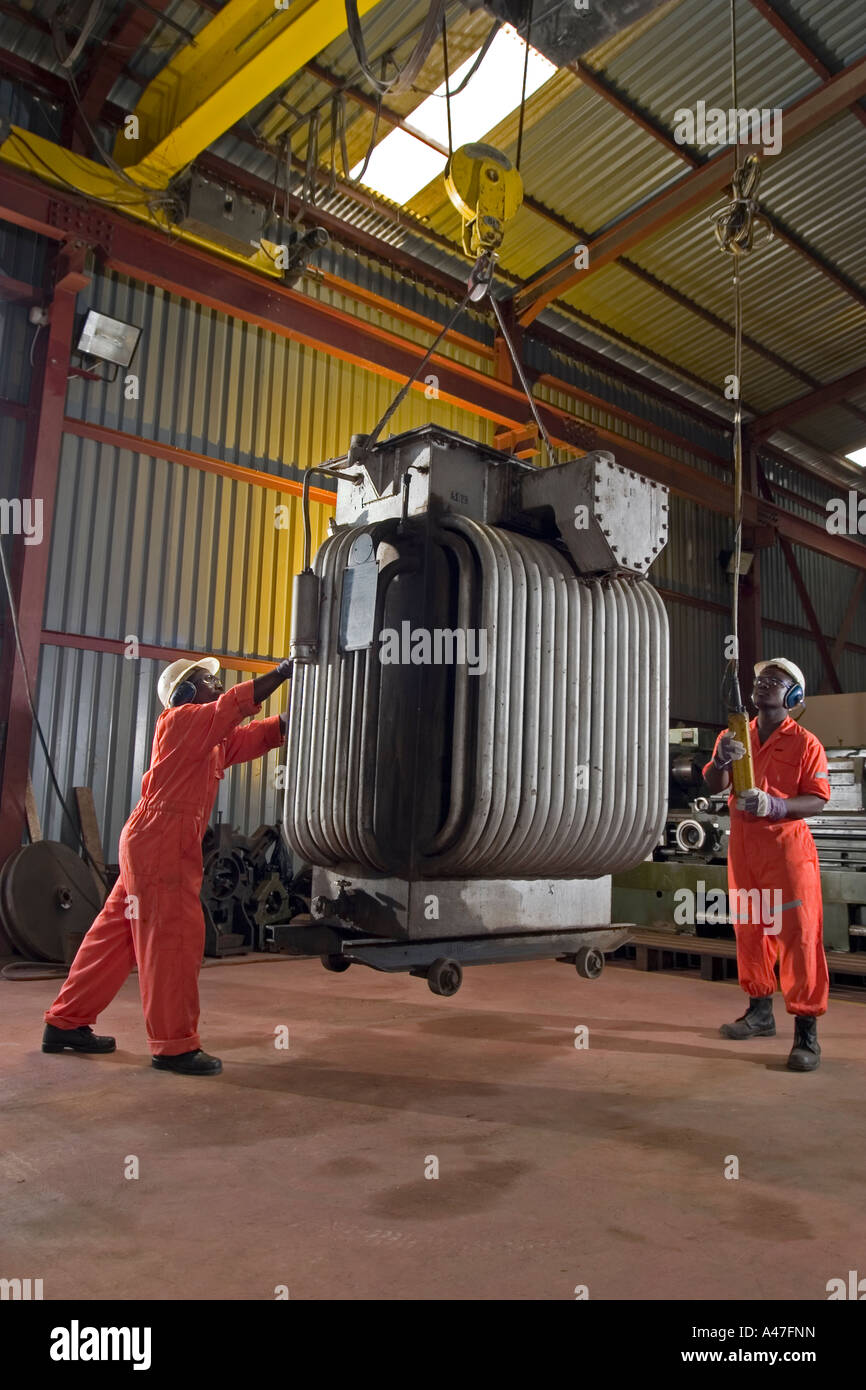 Lifting transformer in maintenance workshop of goldmine, Ghana, West ...