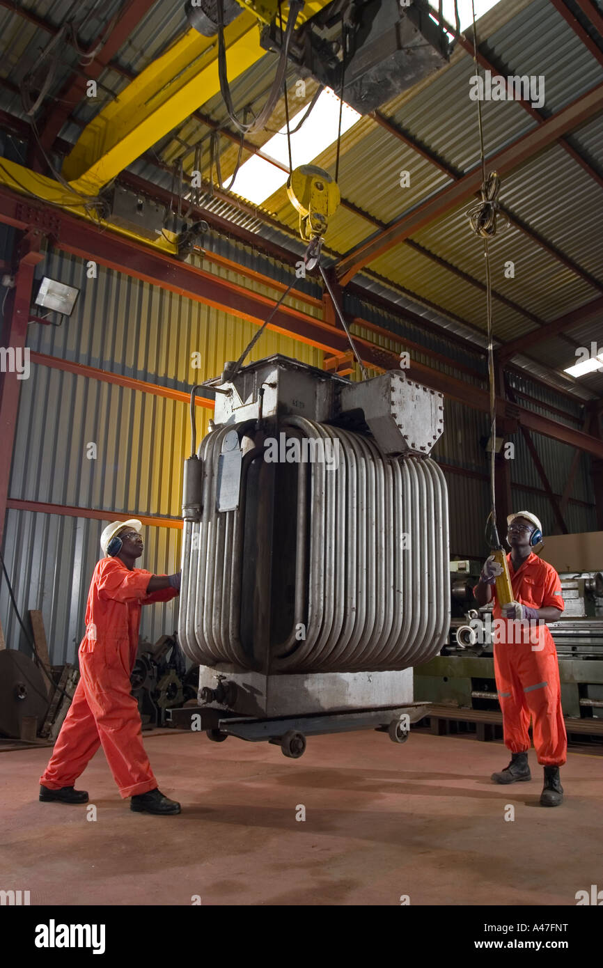 Lifting transformer in maintenance workshop of goldmine, Ghana, West ...