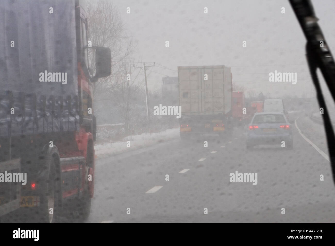 Bad driving conditions in snow and wet weather seen through car ...