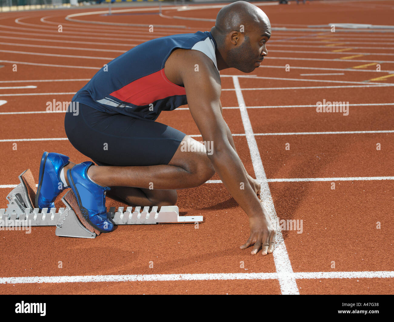 Sprinter at starting line Stock Photo - Alamy