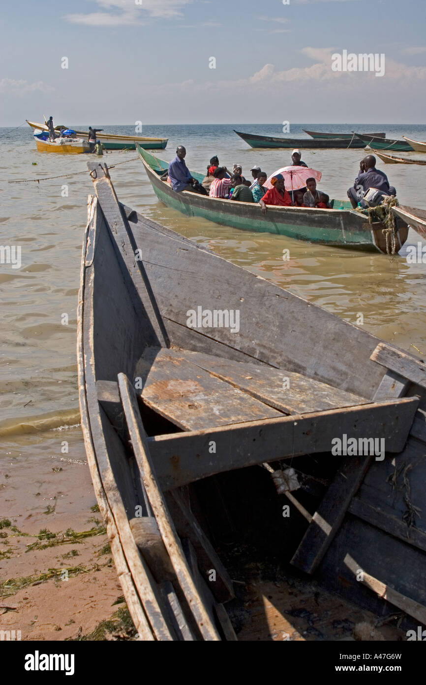 Lakeside scene of fishing boats and ferryboat, on shore of Lake Albert ...