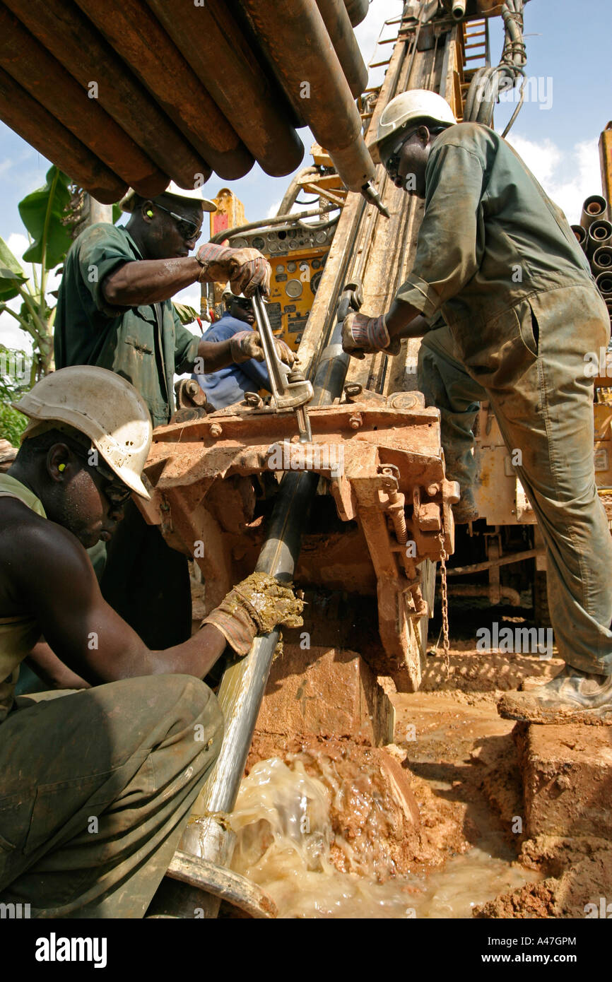 Exploration core drilling, showing offsiders and driller with rig in ...