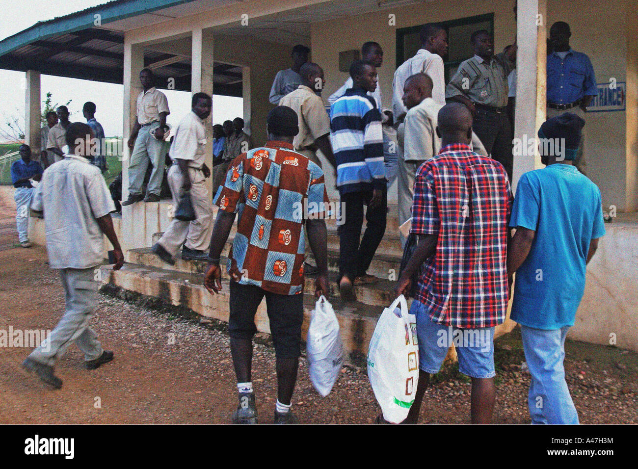 Early morning shift change. Miners arriving for work at Gold mine ...