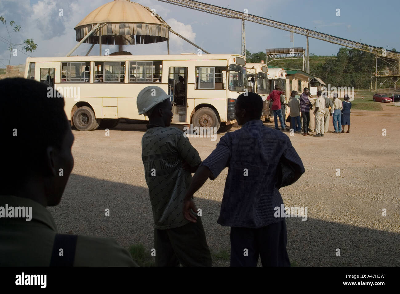 Afternoon shift change. Miners leaving work on buses at Gold mine ...