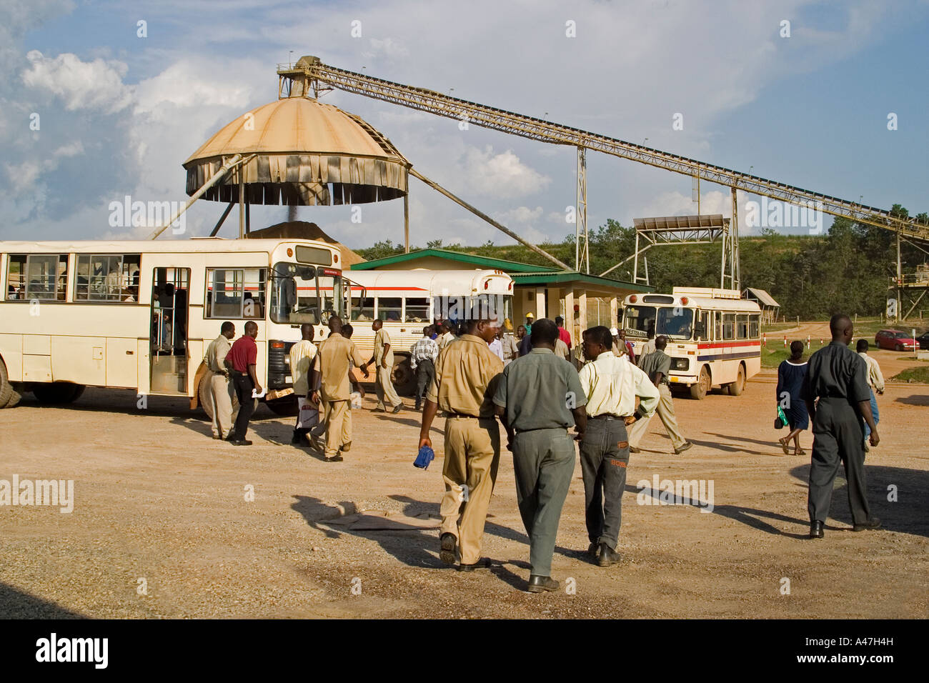 Afternoon shift change. Miners leaving work on buses at Gold mine ...