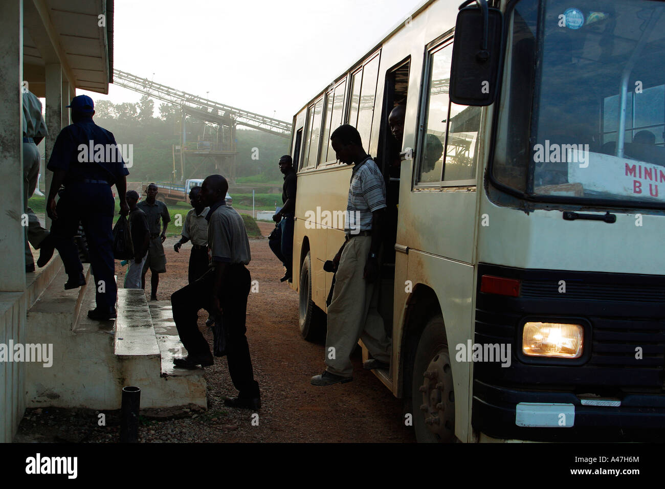 Early morning shift change. Miners arriving for work at gold mine ...