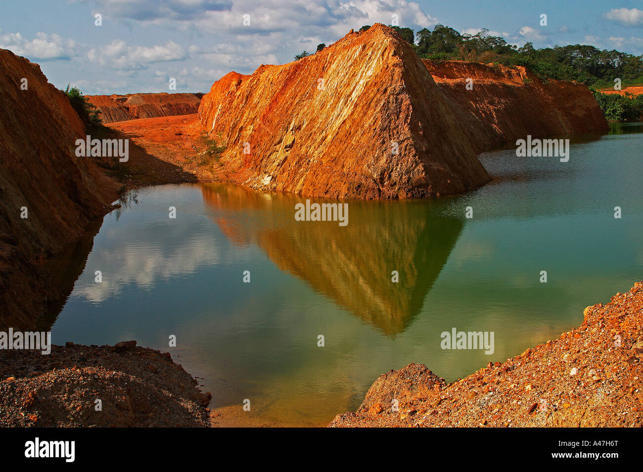 Old mined out opencast gold mine pit before revegetation, Ghana, West ...