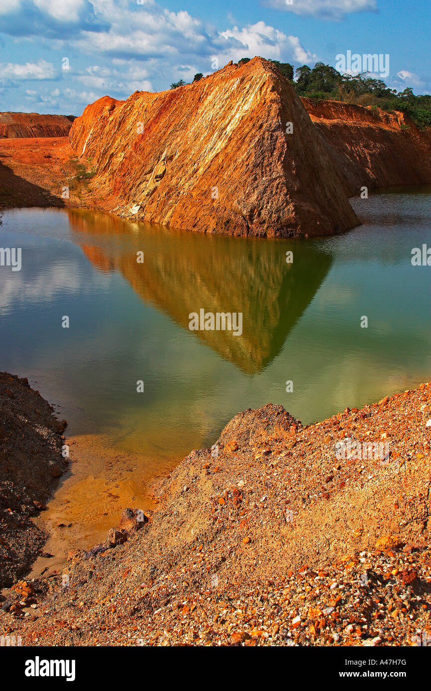Old mined out opencast gold mine pit before revegetation, Ghana, West ...