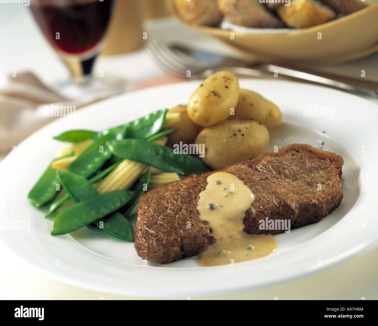 A plate of steak and vegetables in a table setting editorial food Stock ...