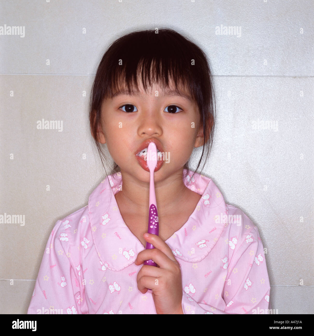 Girl brushing her teeth Stock Photo - Alamy