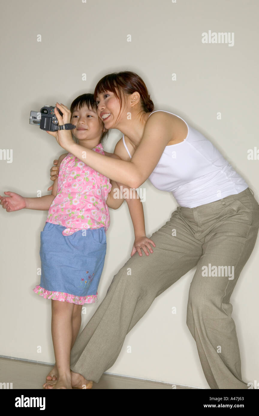 Mother and daughter using video camera Stock Photo - Alamy