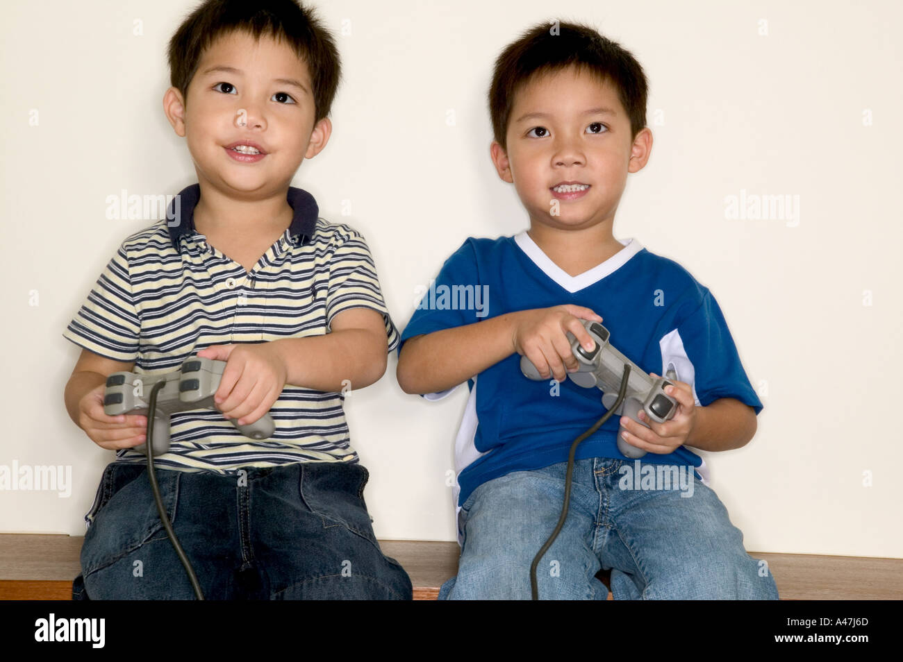 Boys playing video game Stock Photo - Alamy