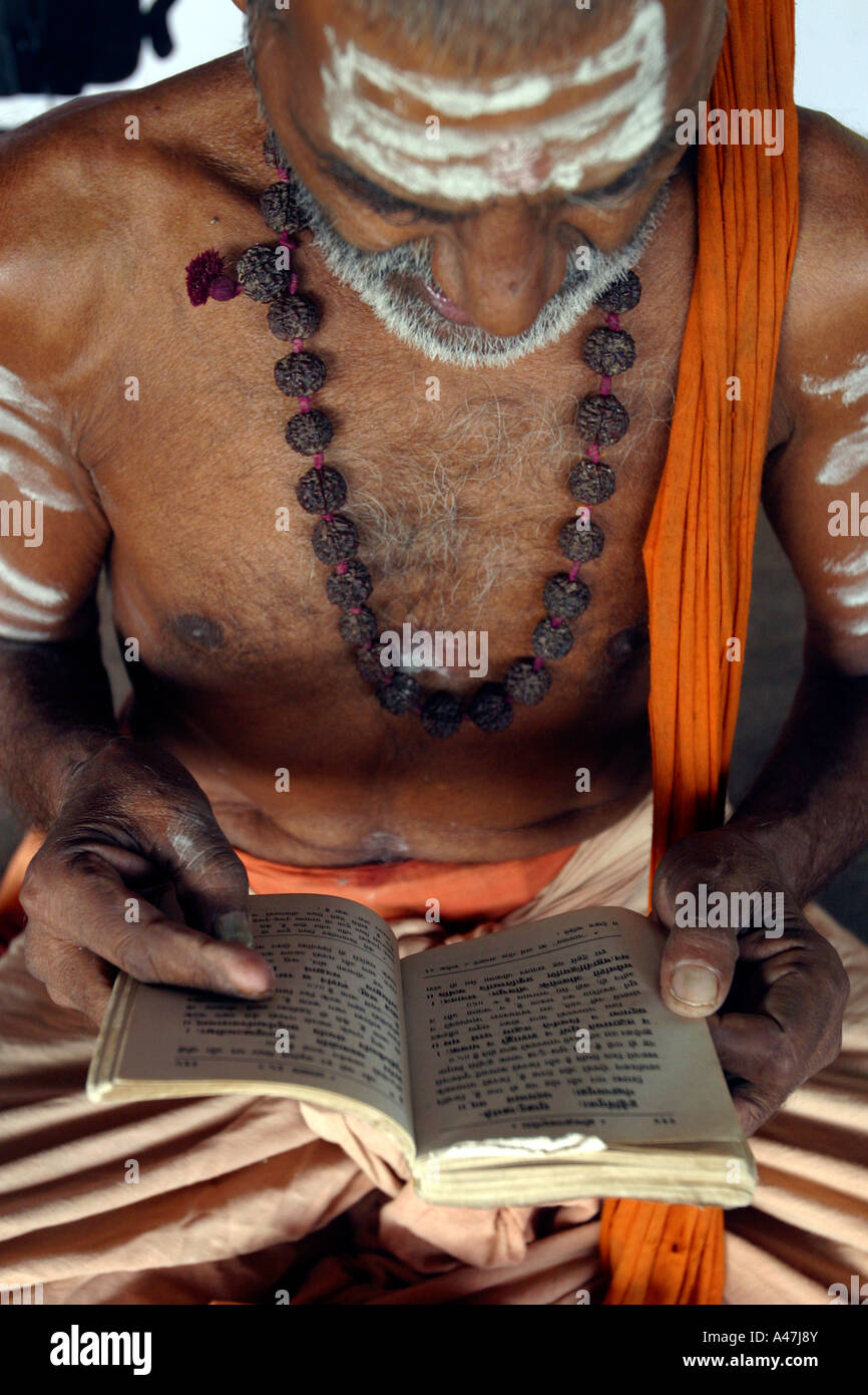 A Hindu devotee reads a religious text in New Delhi in India Stock ...
