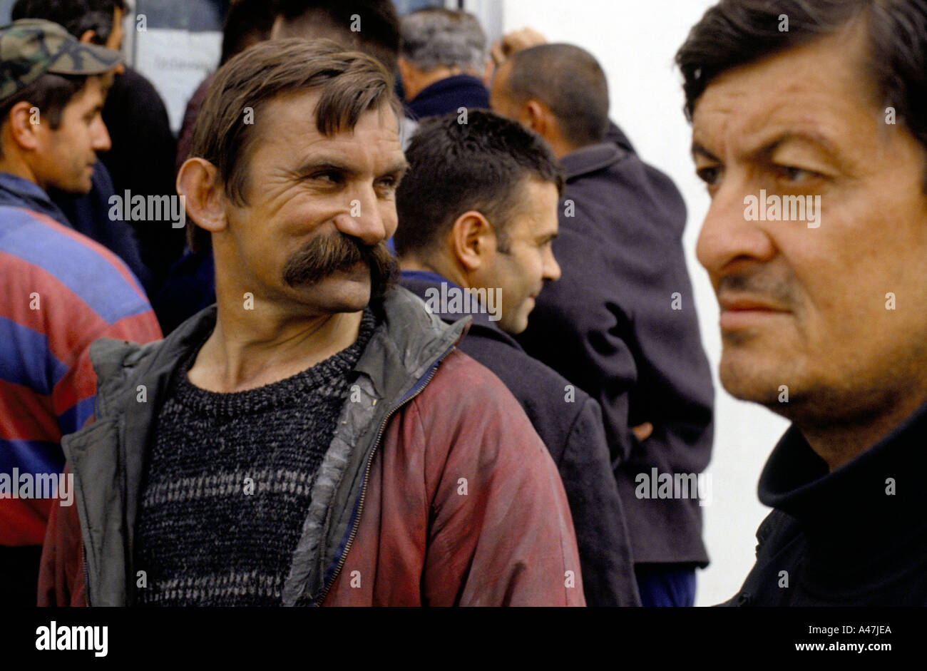 Workers at an aluminium smelting plant collecting safety clothing ...