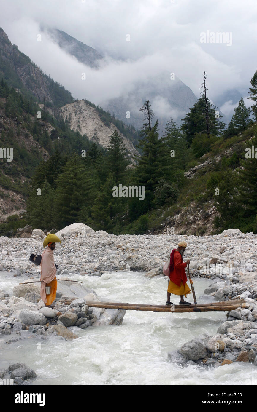 Hindu pilgrims cross the Ganges on a basic bridge on their way to the ...