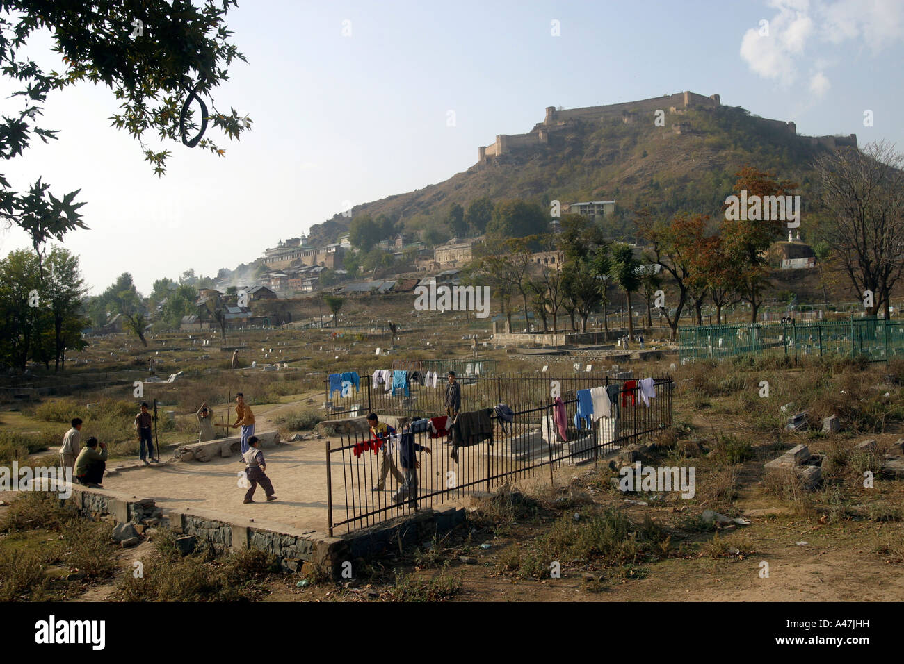 Children play cricket in Srinagar's main graveyard in Kashmir in India ...