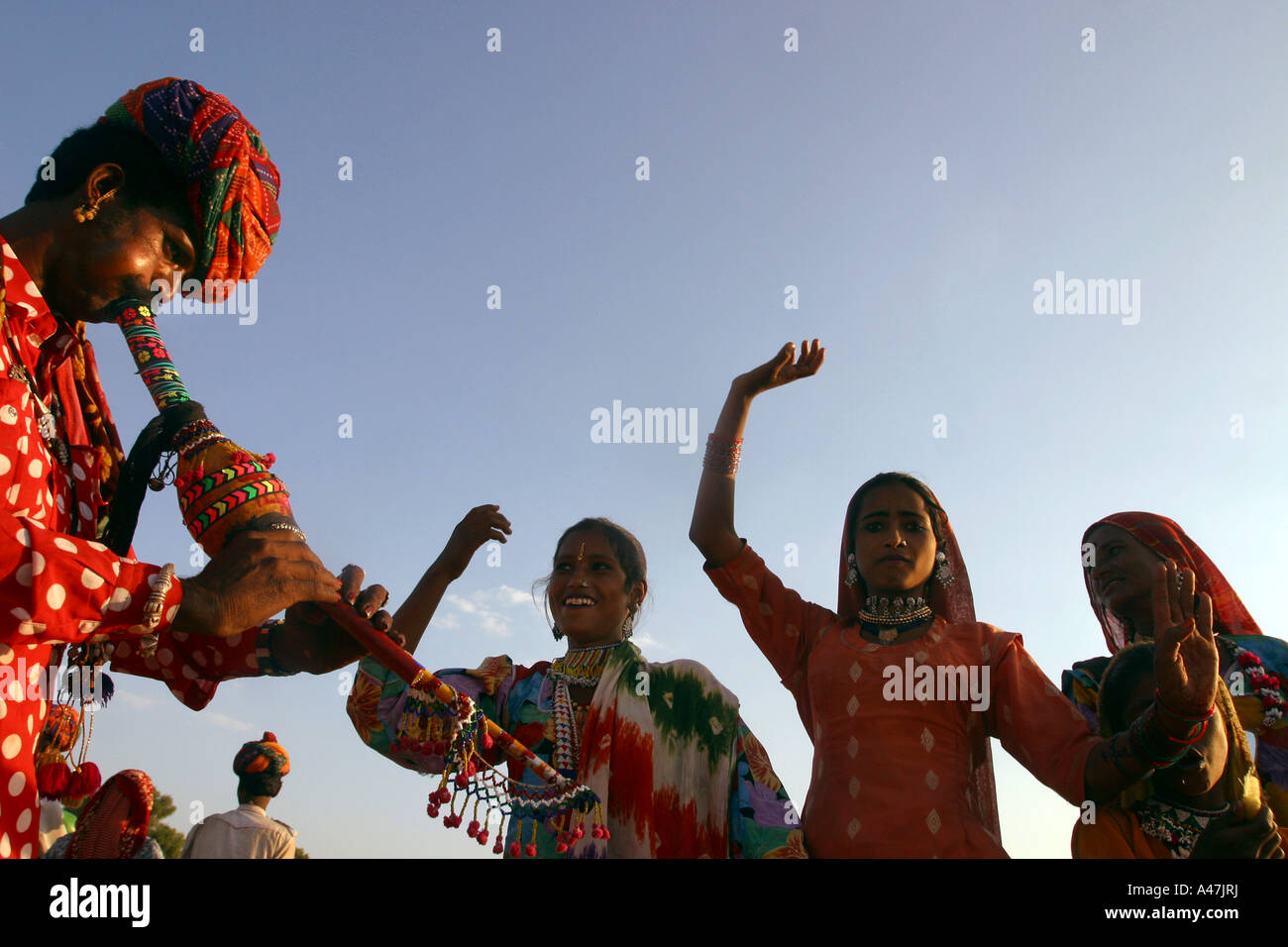 A musician and a group of dancers perform during the annual Pushkar ...